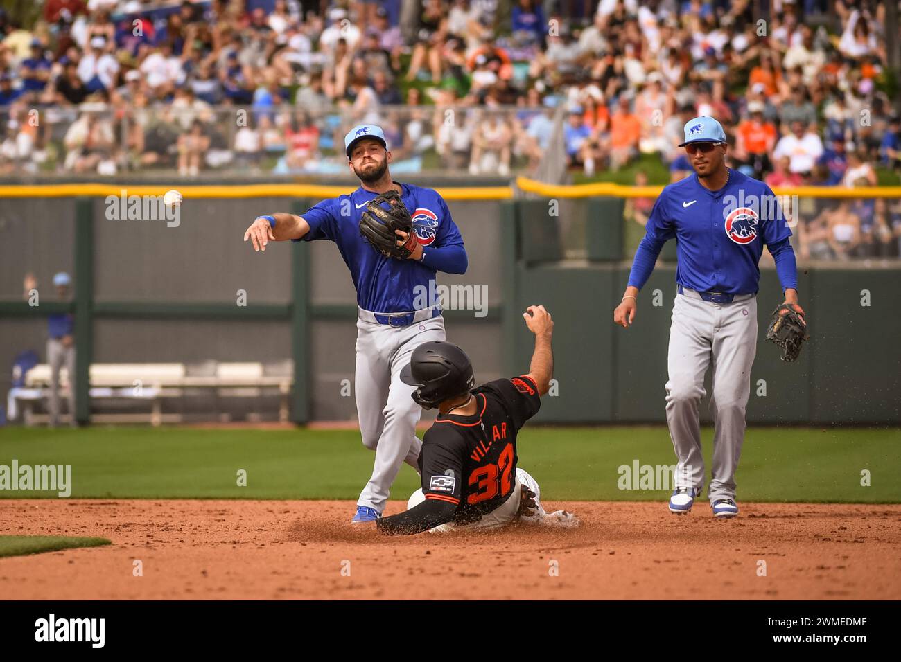Chicago Cubs second baseman David Bone (13) turns a double play in the ...