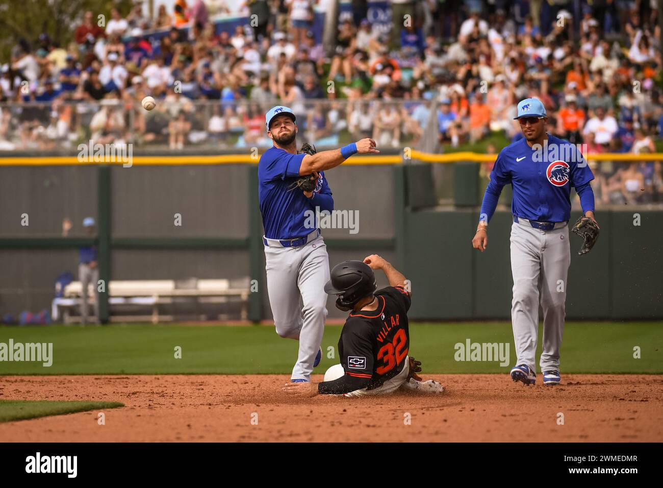 Chicago Cubs second baseman David Bone (13) turns a double play in the ...