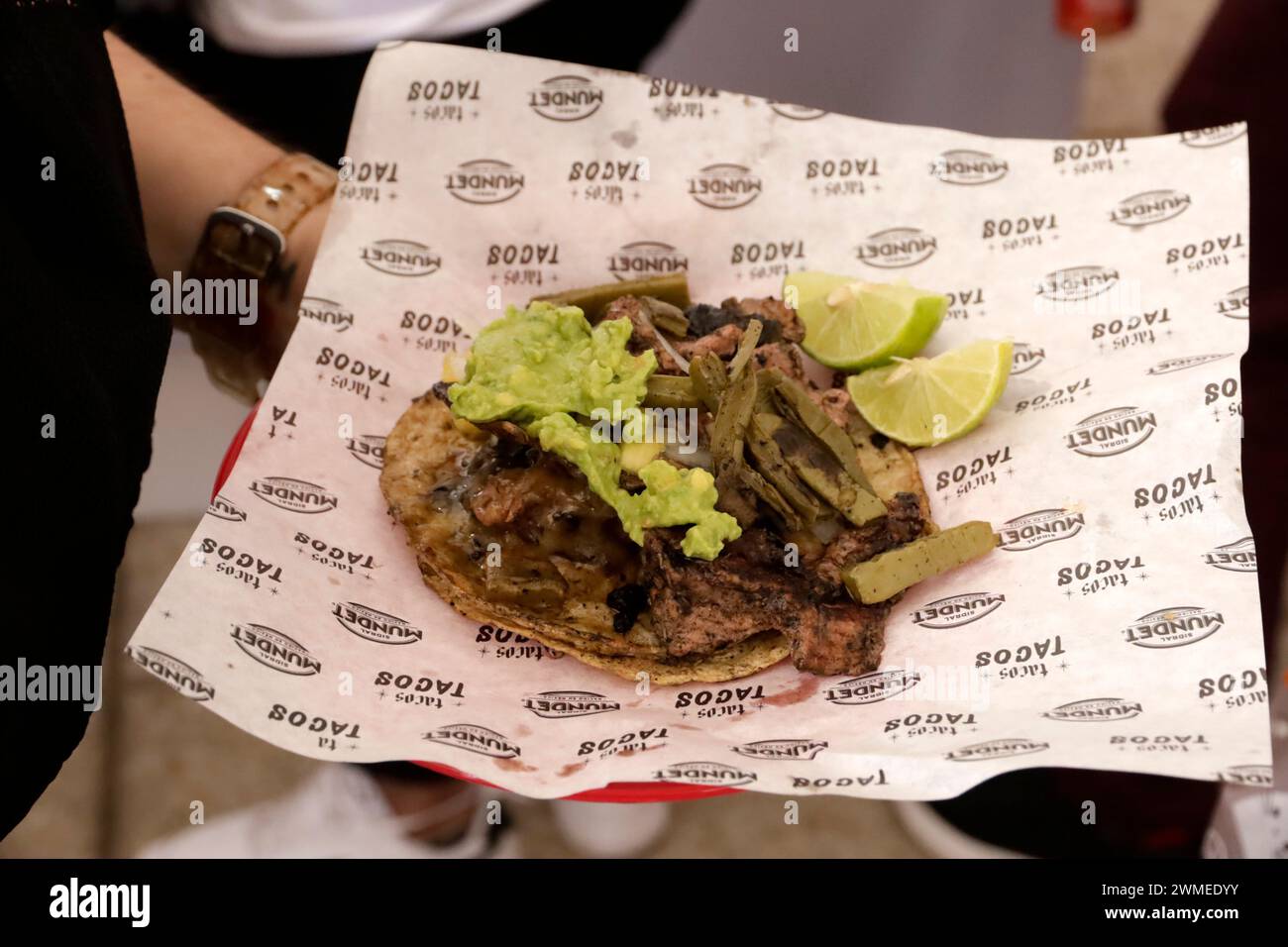 Mexico City, Mexico. 24th Feb, 2024. A person enjoy eating a taco ...