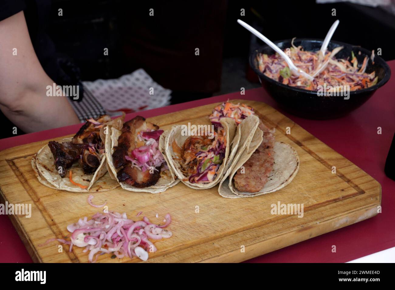 Mexico City, Mexico. 24th Feb, 2024. A taquero cooks tacos during the ...