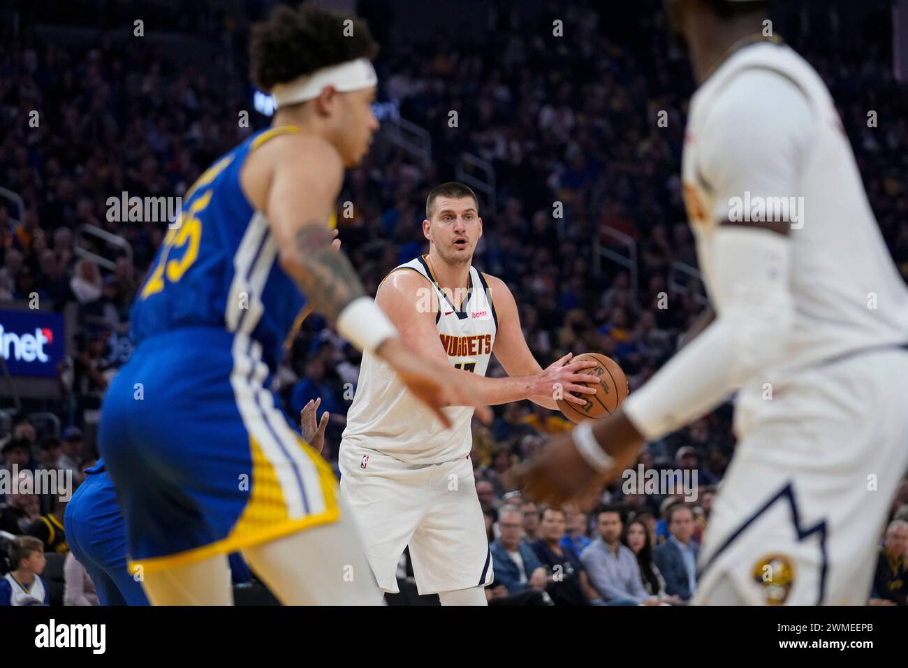 Denver Nuggets center Nikola Jokic, center, looks for an open teammate ...