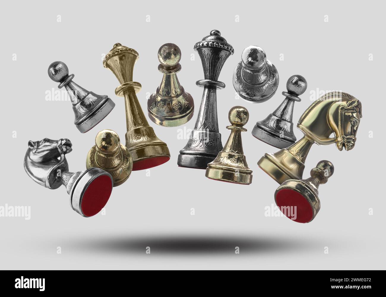 Different chess pieces falling on light grey background Stock Photo - Alamy
