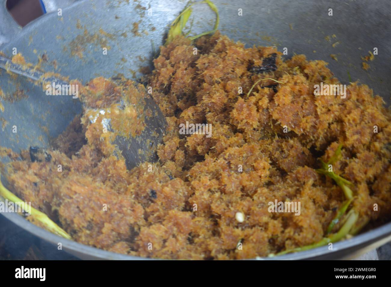 The process of making serundeng made from shaved coconut dregs, a ...