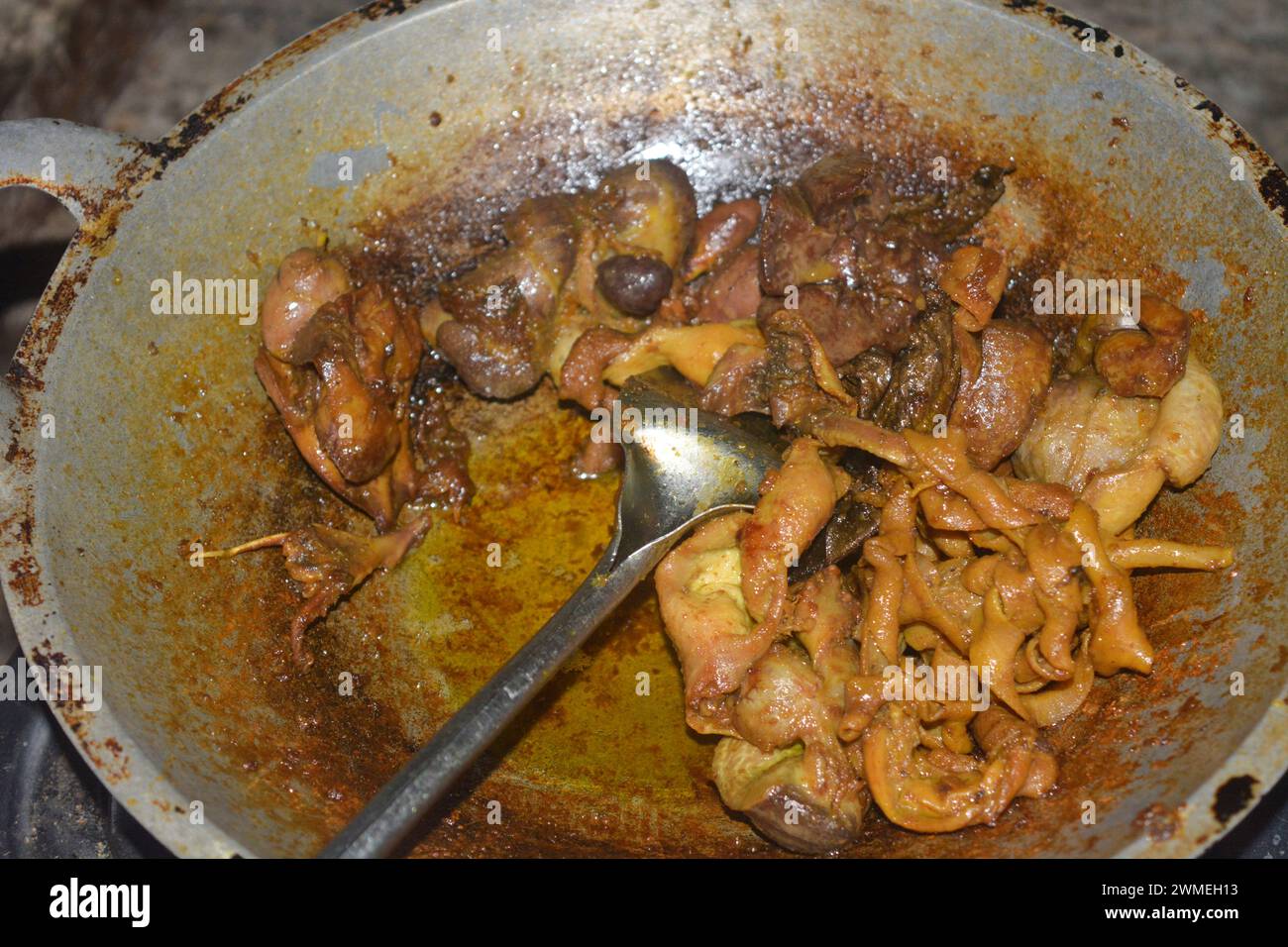 Photo of chicken being cooked on a cauldron Stock Photo - Alamy