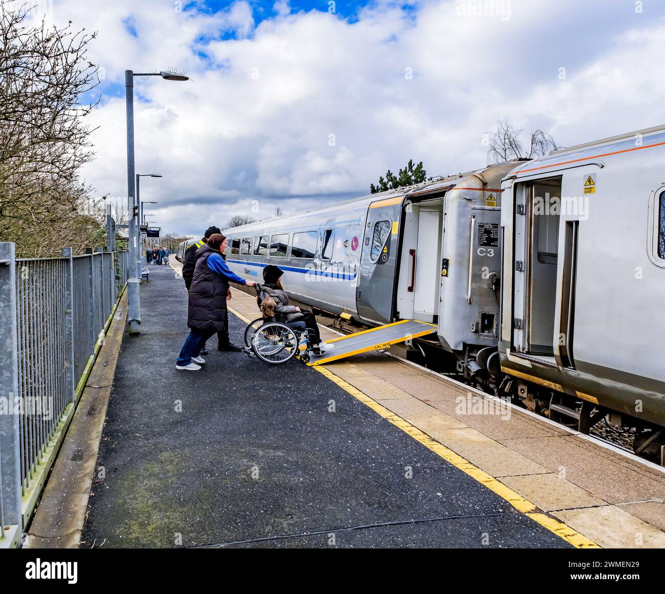 a disabled person being pushed by carer up a disability ramp british ...