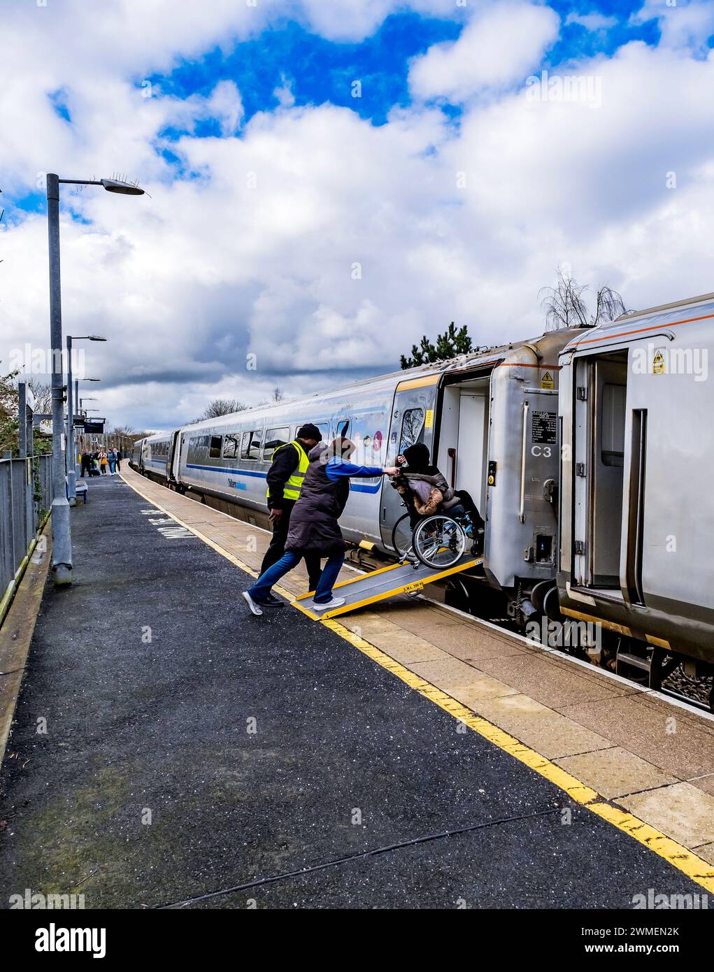 a disabled person being pushed by carer up a disability ramp british ...