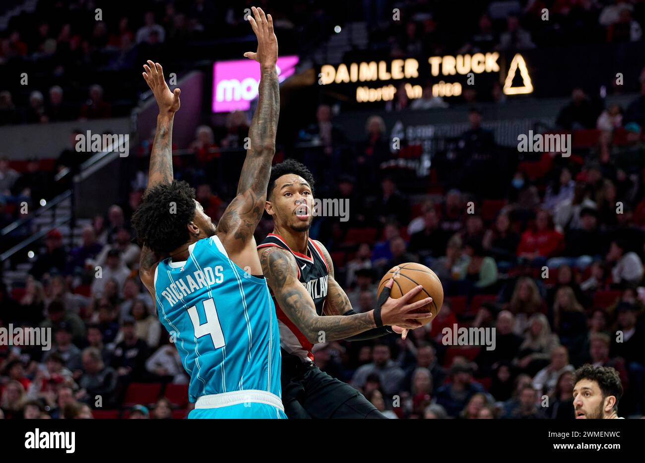 Portland Trail Blazers guard Anfernee Simons, right, shoots over ...
