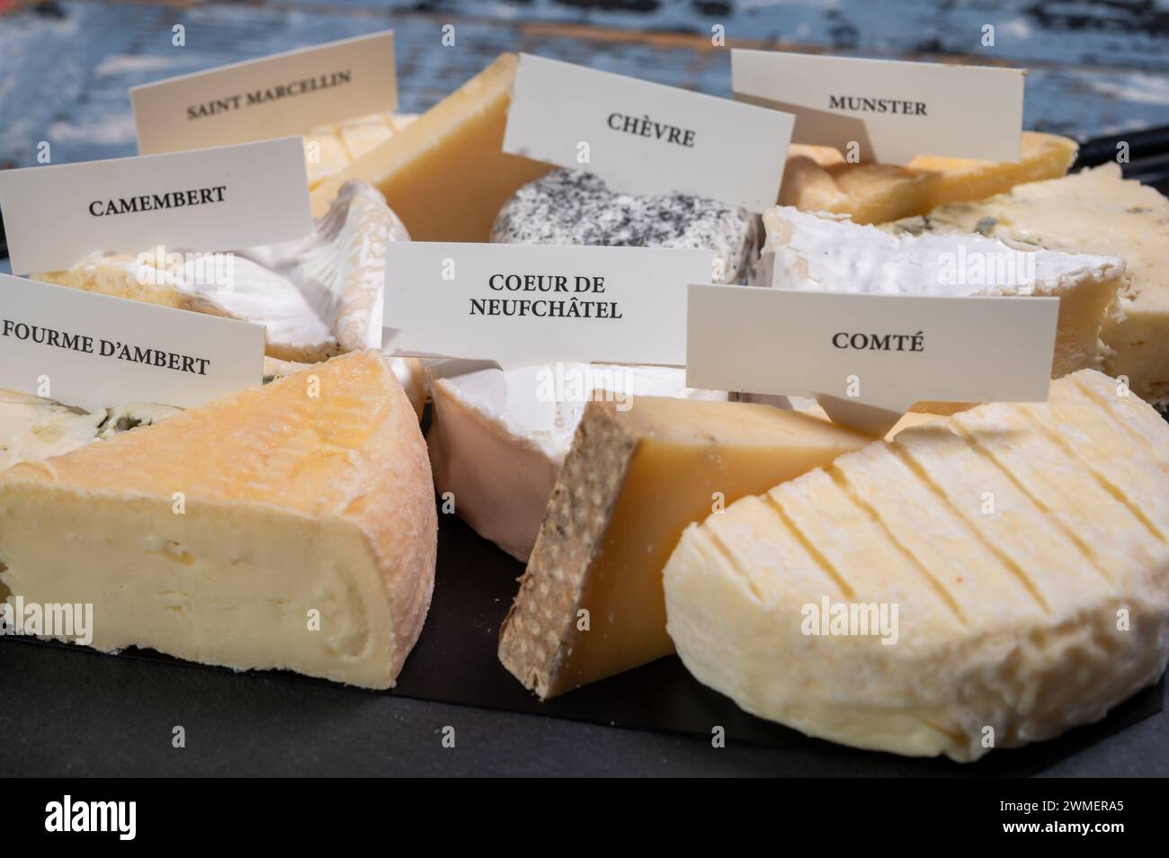 Tasting plate with small pieces of different French cheeses with name ...