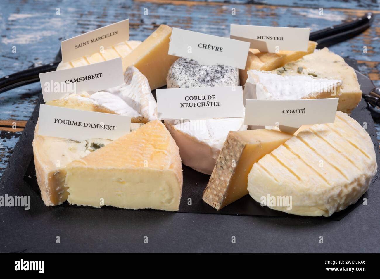 Tasting plate with small pieces of different French cheeses with name ...