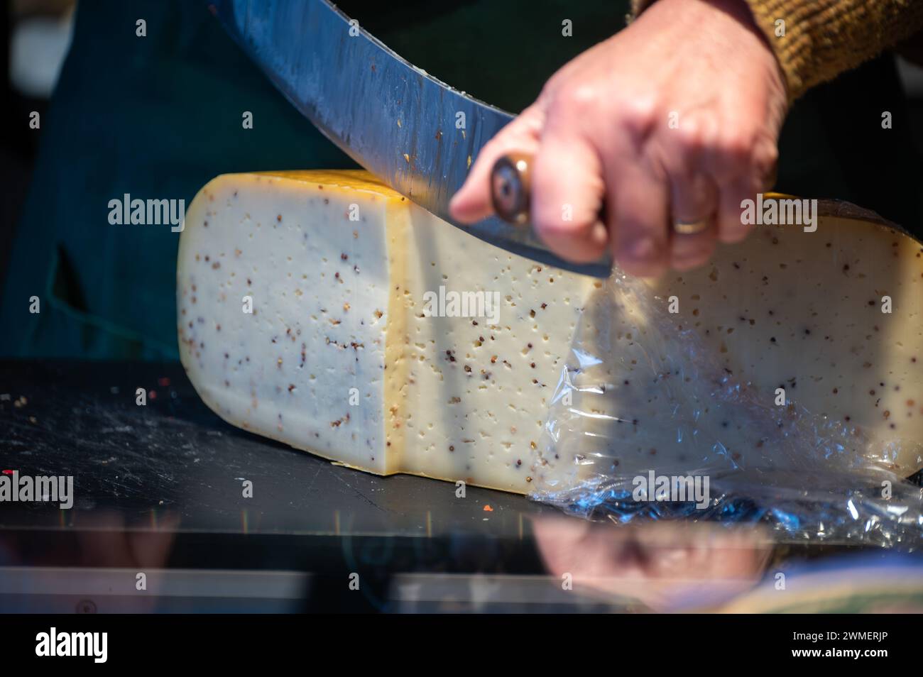 Cutting and tasting of different cheeses and sausages in Dutch cheese ...