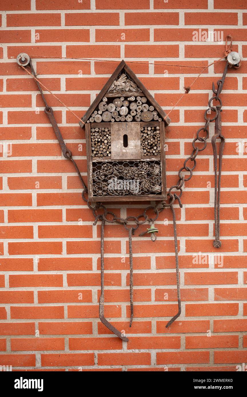 Wooden insects hotel for bugs en bees on brick wall, nature concept ...