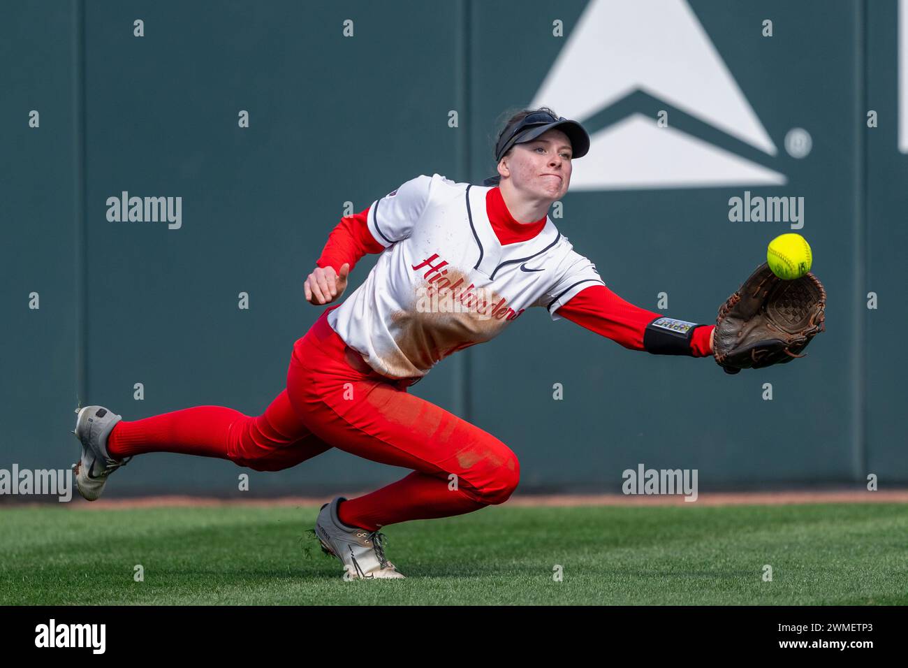 Radford University outfielder Lexie Robert (14) dives for a catch ...