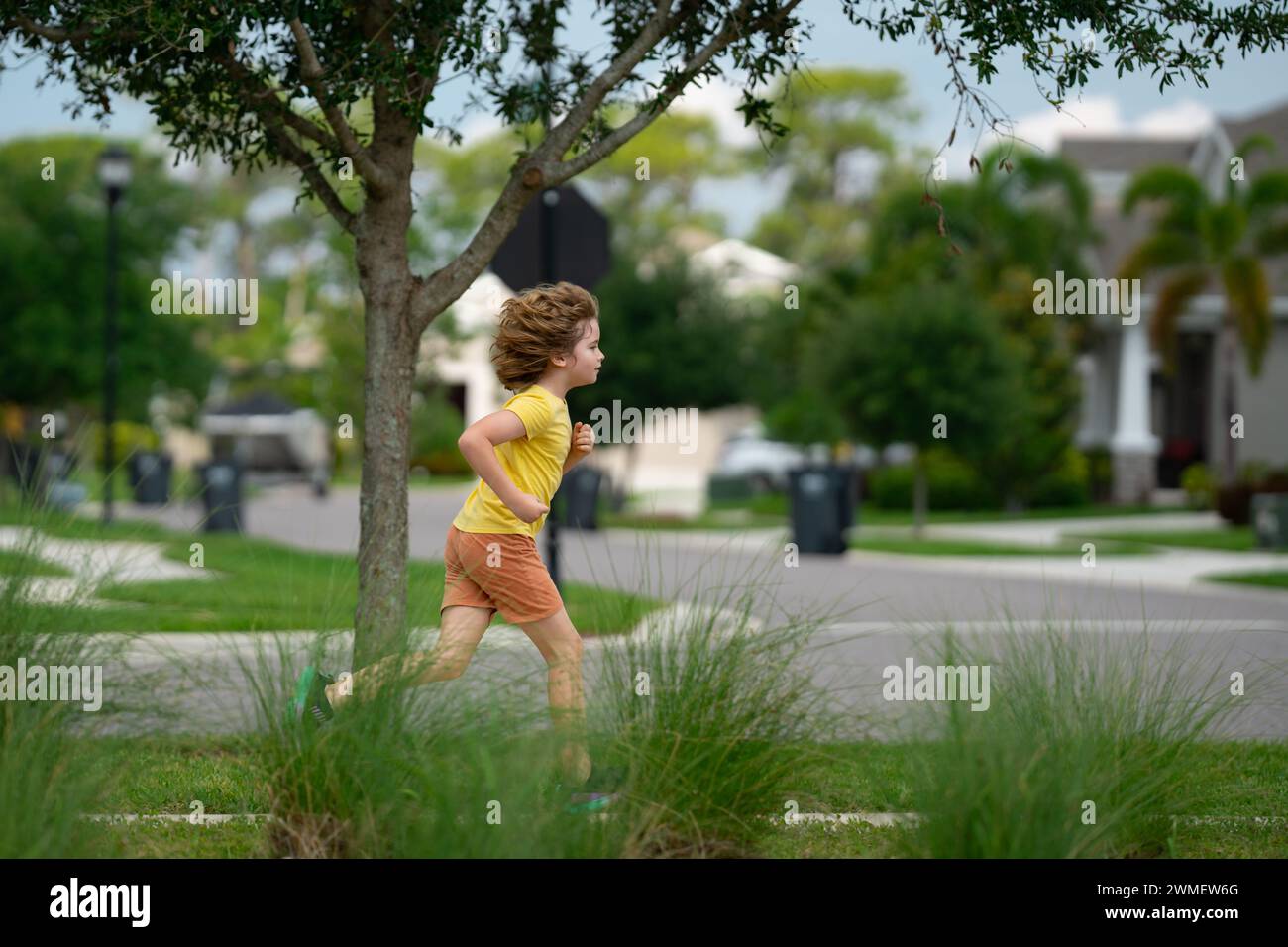 Kid running in summer street. Child enjoy run. Little boy running on ...