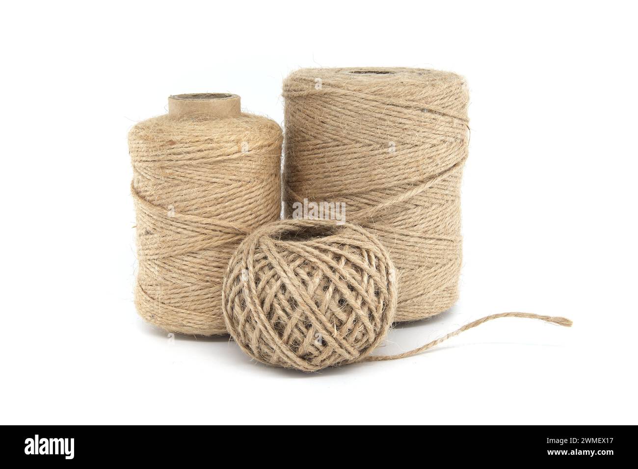 Three spools of jute twine isolated on white background, each varying ...