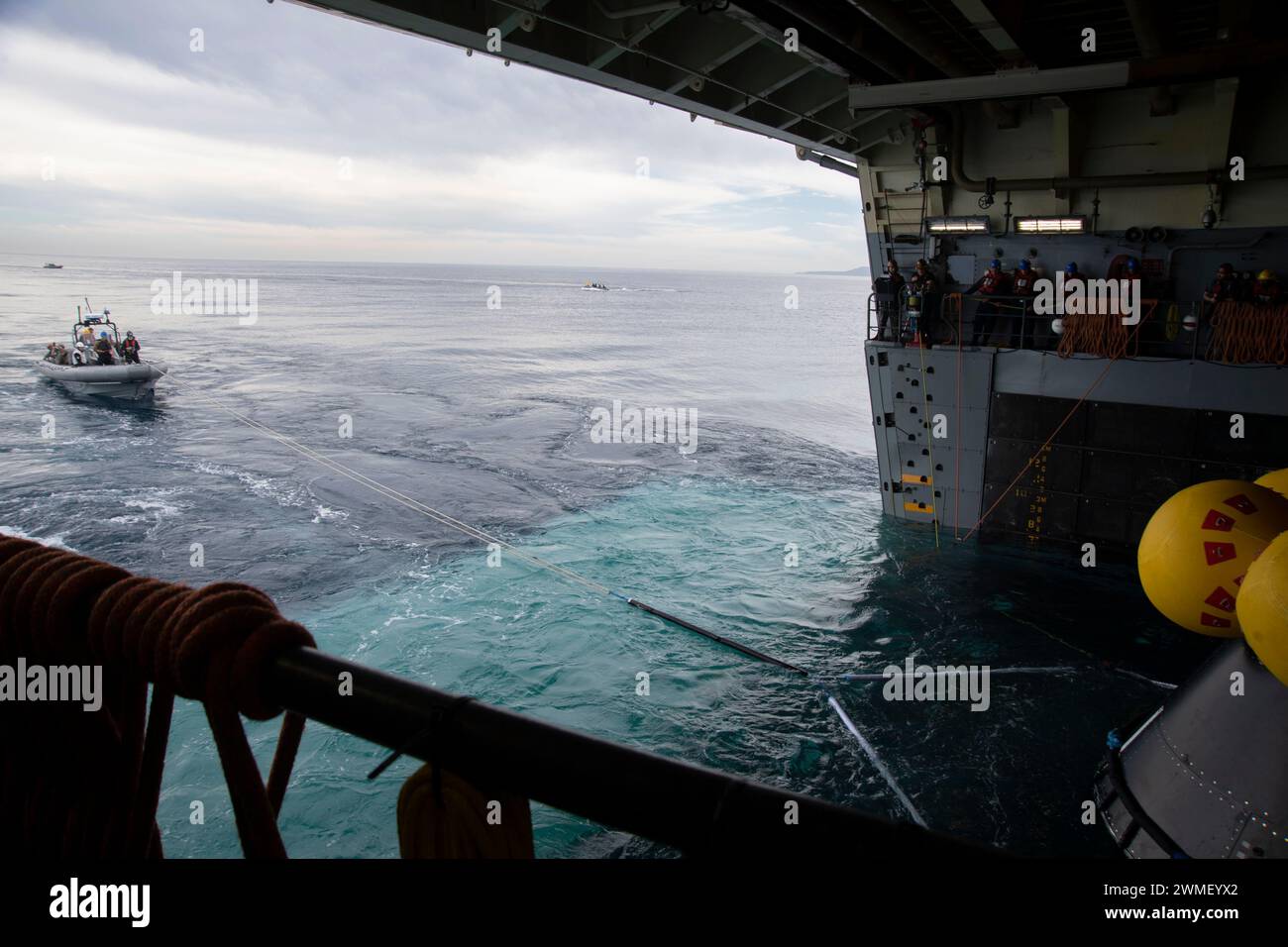 U.S. Navy Sailors connect an 11 meter rigid hull inflatable boat to ...