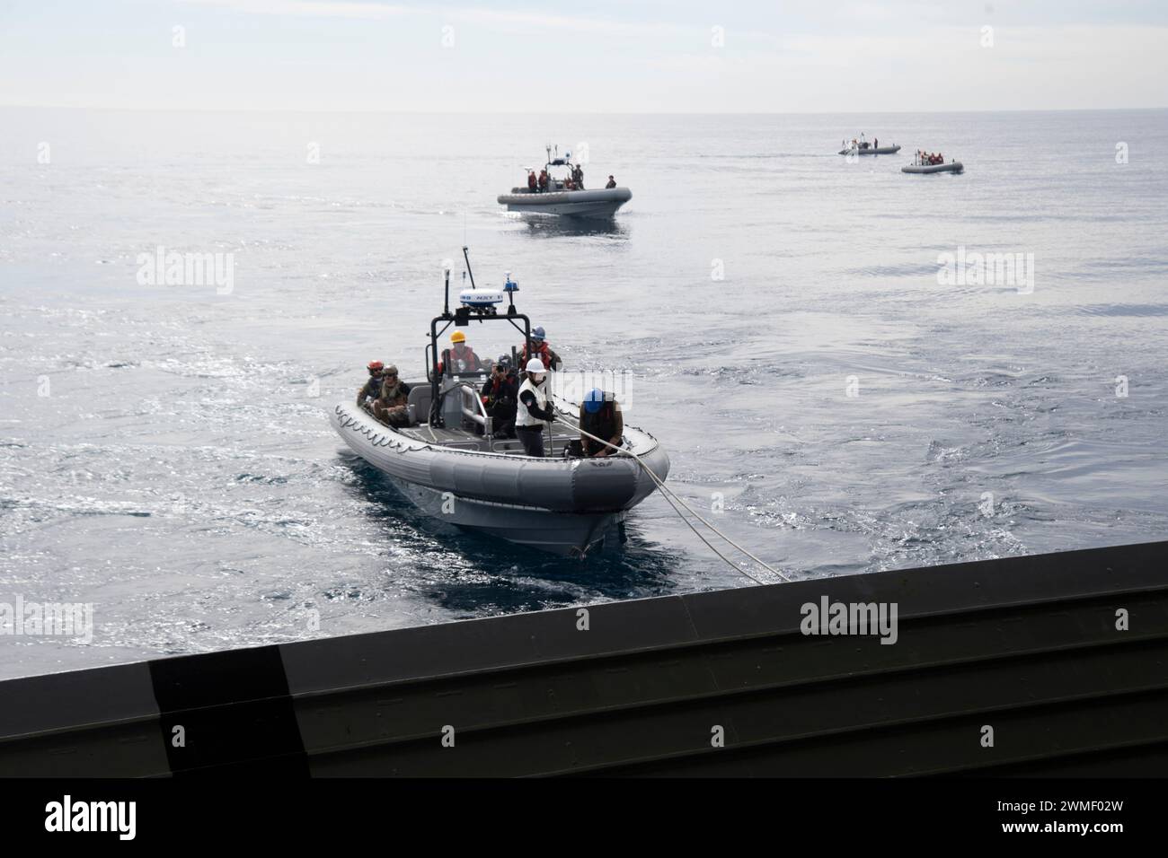 U.S. Navy Sailors connect an 11 meter rigid hull inflatable boat to ...