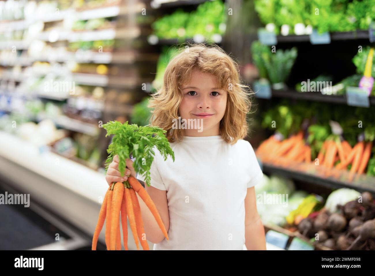 Child choosing vegetables in supermarket store. Kids in food ...