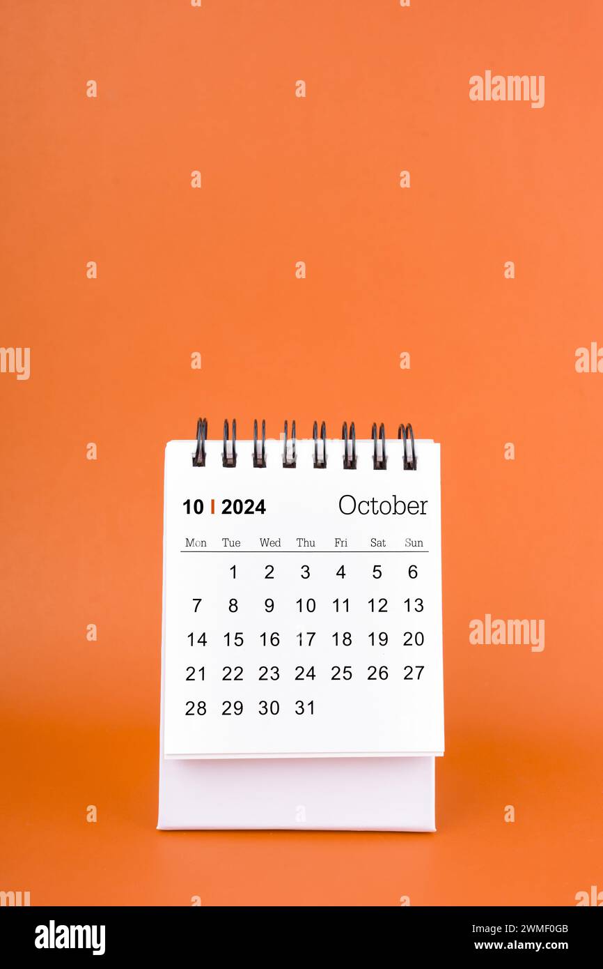 Vertical of October 2024 table calendar on orange color background ...