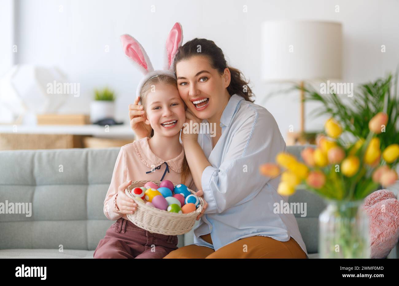 Happy holiday! Mother and her daughter with painting eggs. Family ...