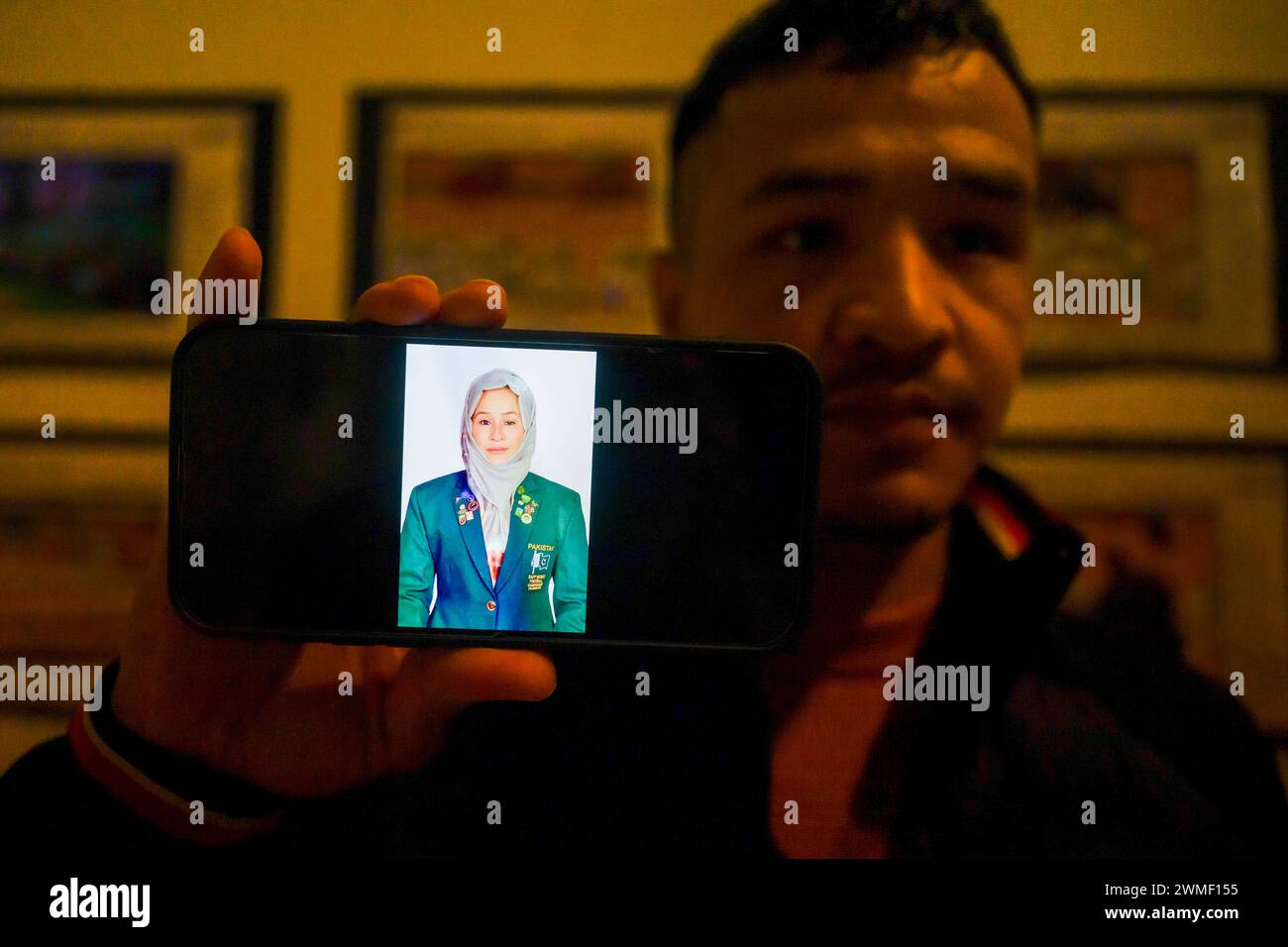 Ali Raza, 24, from Pakistan, shows his phone in Crotone, southern Italy ...