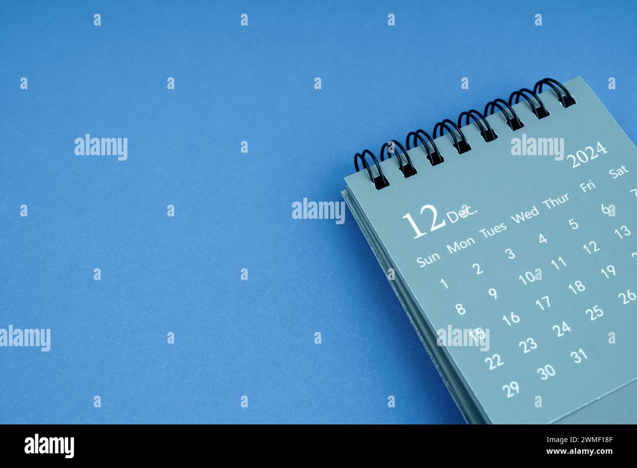 December 2024 desk calendar on blue color background. Copy space Stock ...