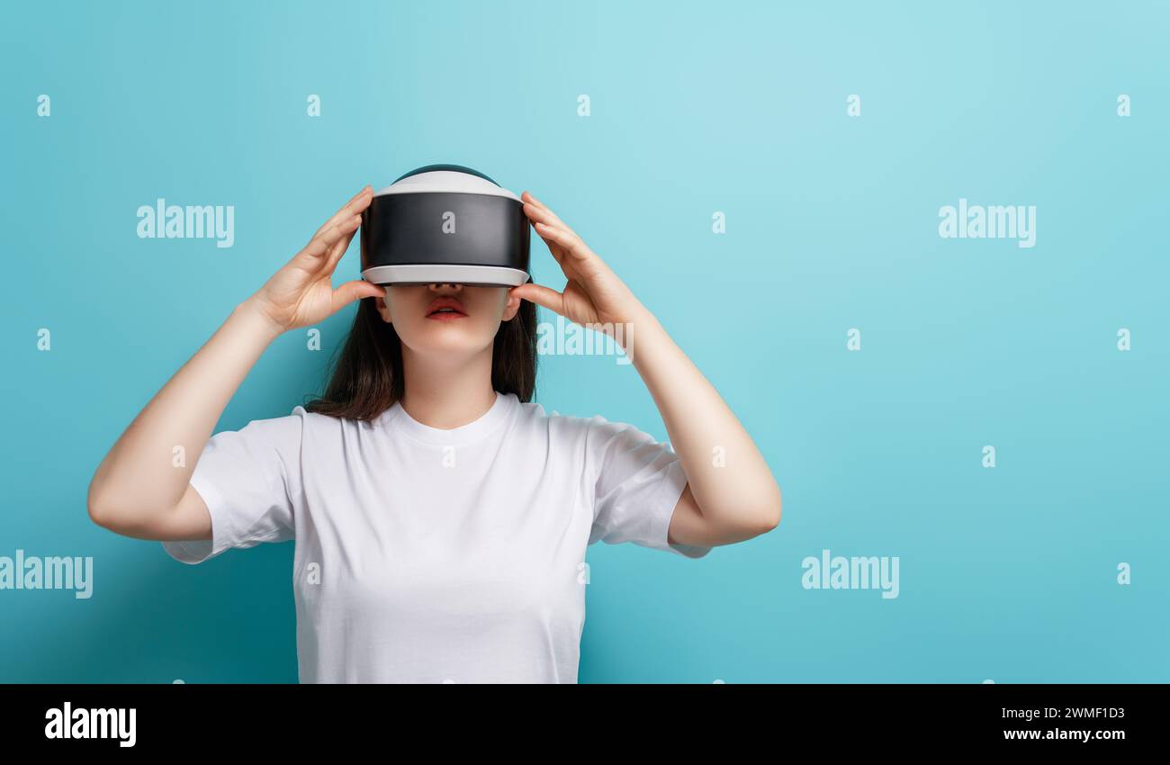 Metaverse technology concept. Woman with VR virtual reality goggles on ...