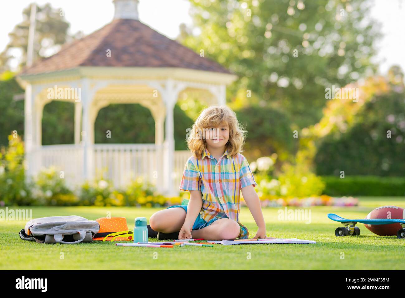 Little artist drawing painting art in park. Cute child boy with books ...