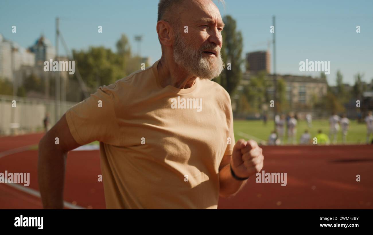 Old European man athlete sportsman running stadium city outside runner ...