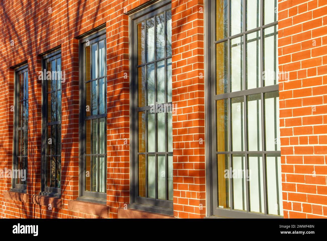 Brick building windows with shadows Stock Photo - Alamy