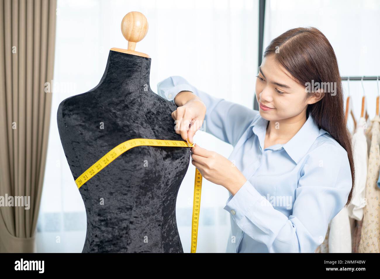 The female designer is working on measuring the dimensions of a ...