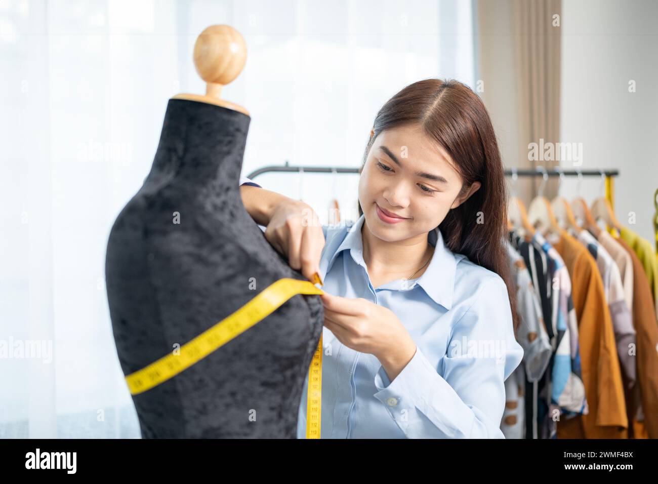 The female designer is working on measuring the dimensions of a ...