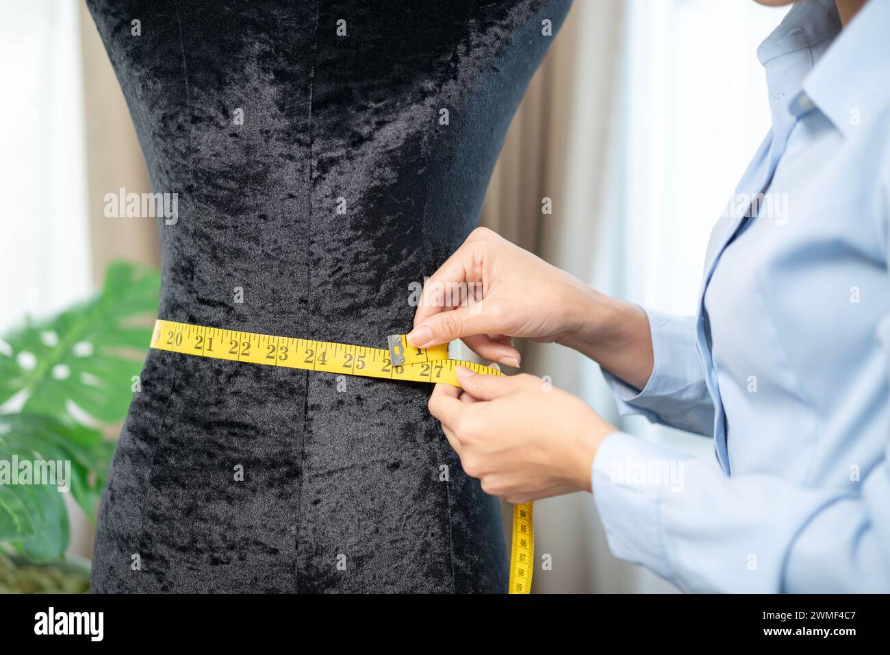 The female designer is working on measuring the dimensions of a ...