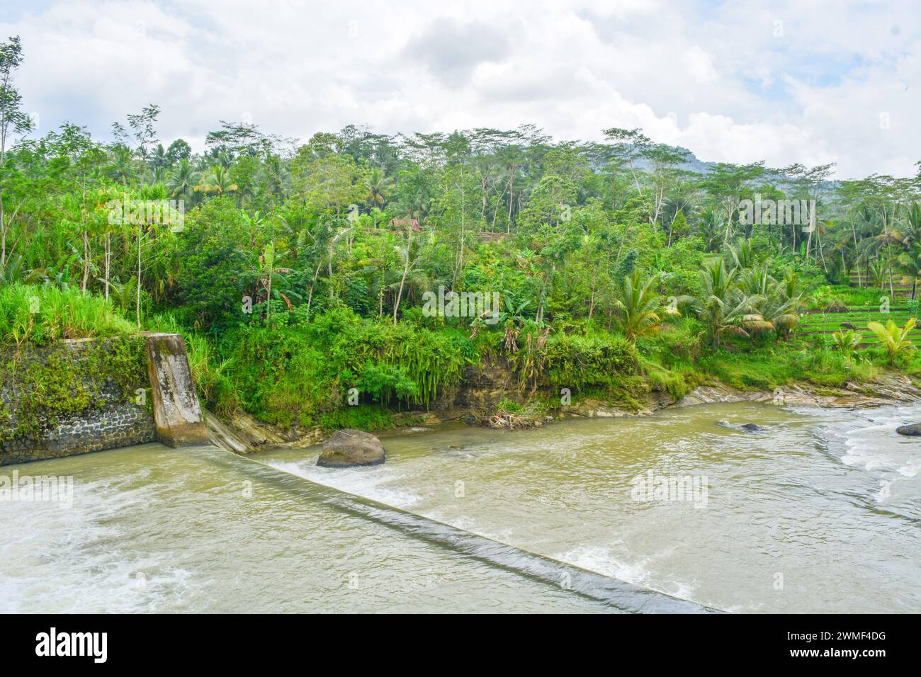 A fast-flowing stream and dramatic lenticular clouds against a dark sky ...