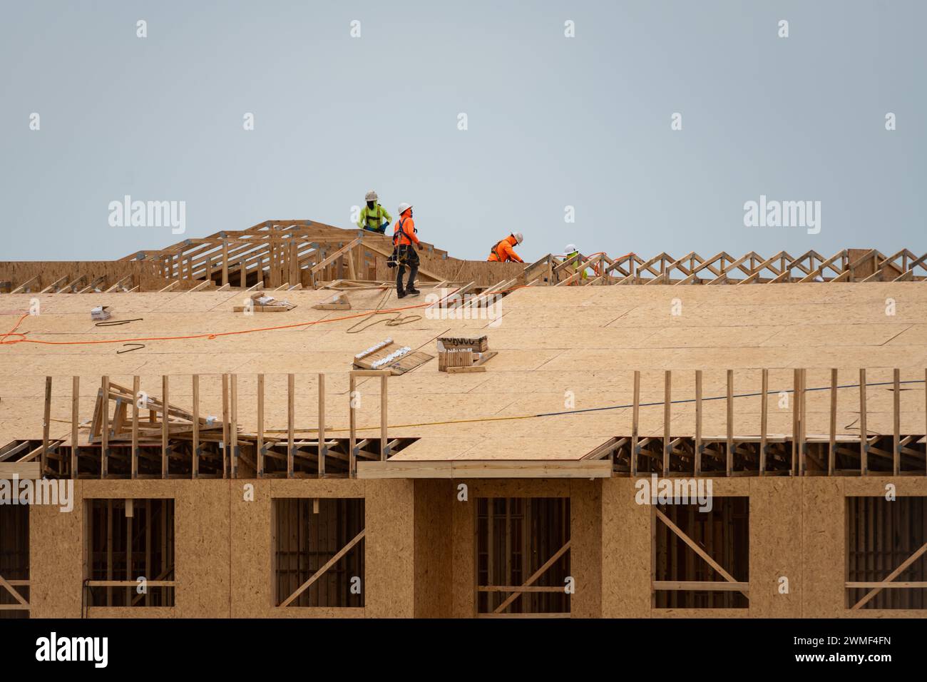 Wooden roof. Roofs repair. Roofer worker install new roof on top roof ...