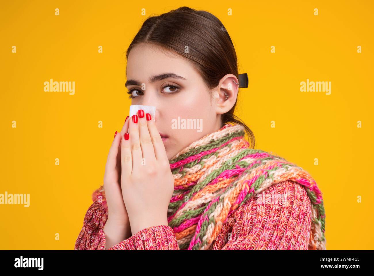 Blow the snot. Woman in sweater and scarf hold napkin blow snot ...