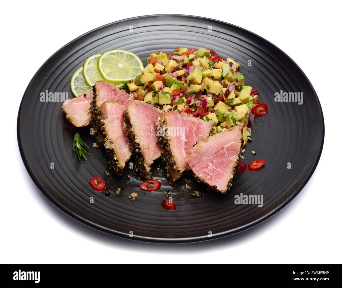 Sliced Organic grilled Tuna fillet covered with sesame seeds and salsa ...