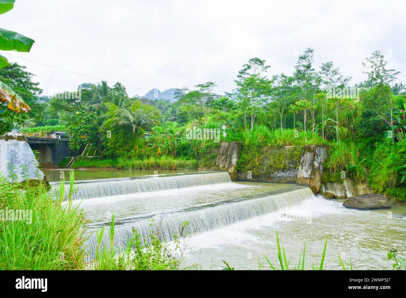 A fast-flowing stream and dramatic lenticular clouds against a dark sky ...