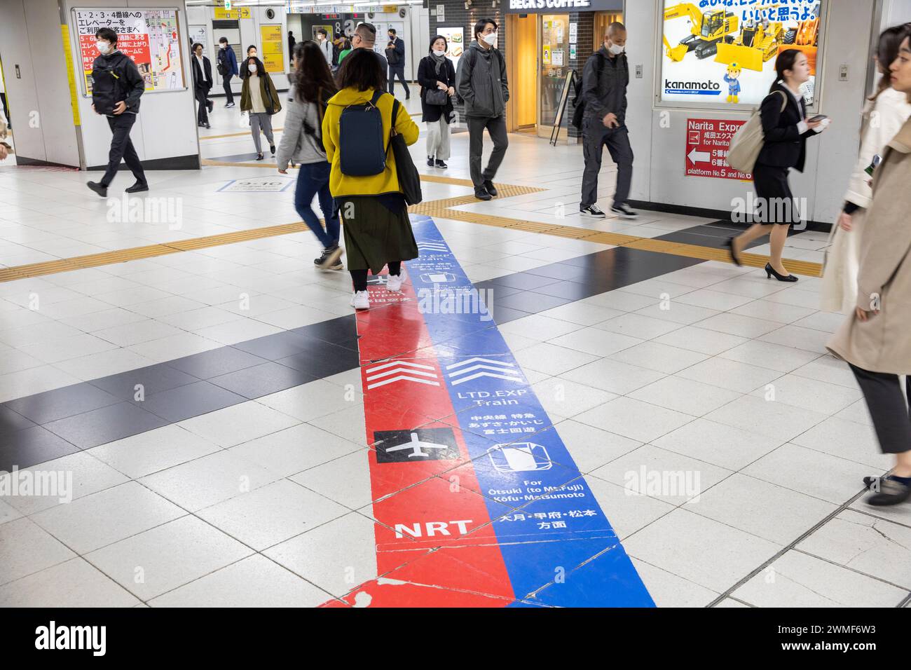 Tokyo railway station metro, red and blue floor markings indicate ...