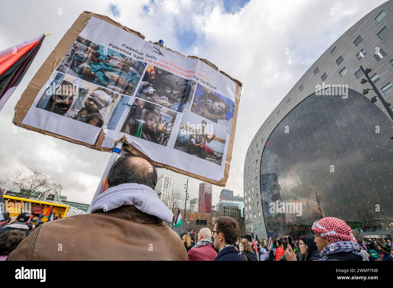 A protester holds a placard during the Open Off Rafah protest. HANDS ...
