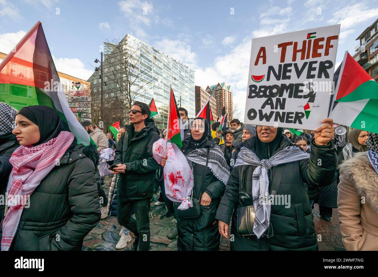A protester holds a placard during the Open Off Rafah protest. HANDS ...