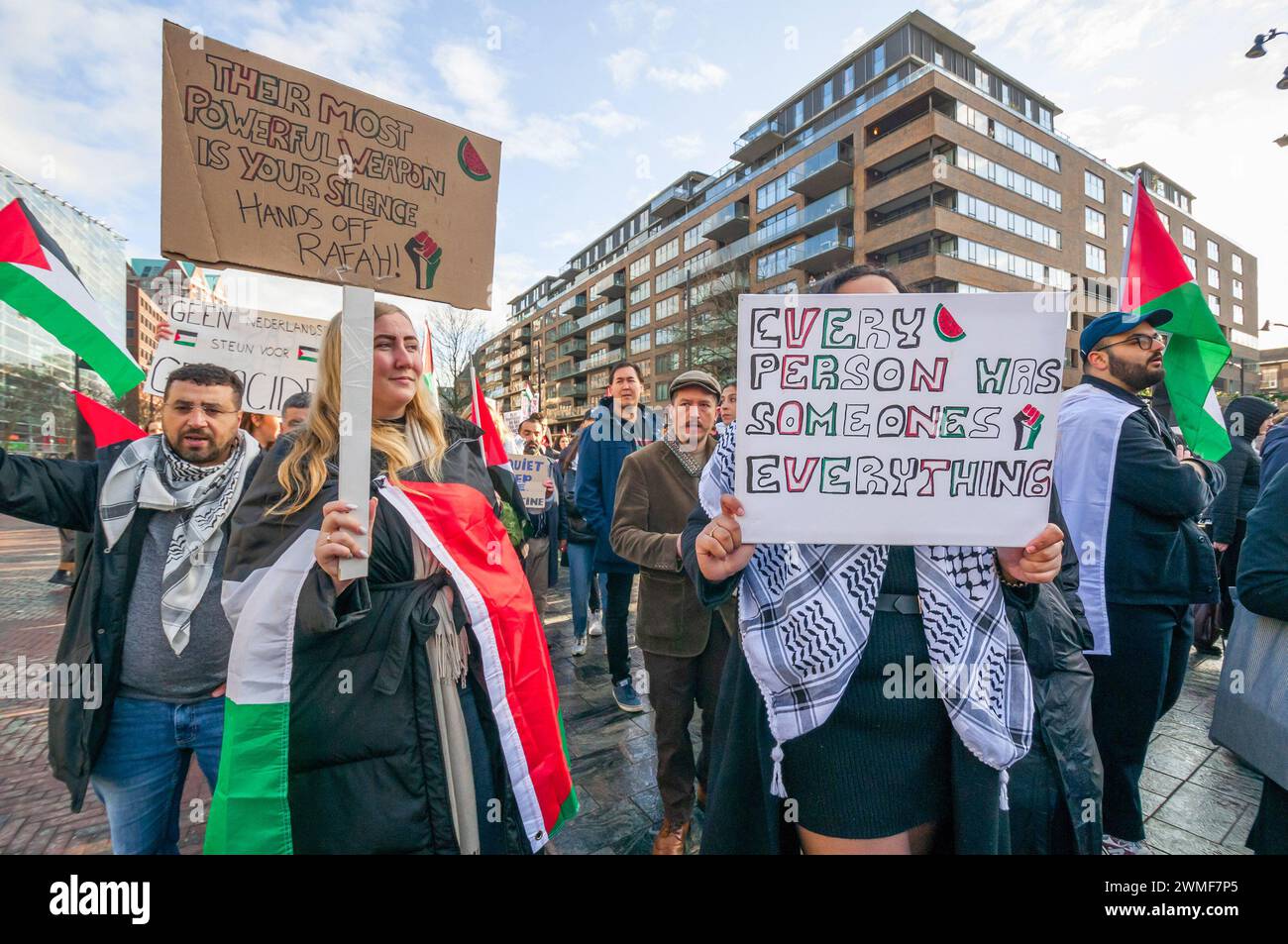 Demonstrators hold placards expressing their opinion, during the Open ...