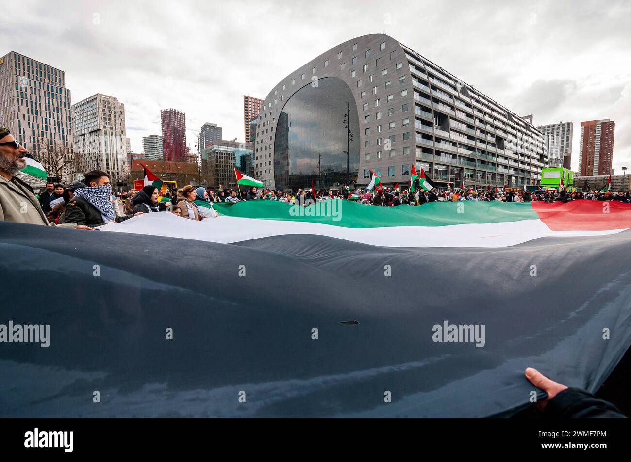Demonstrators hold large Palestinian flag during the Open Off Rafah ...