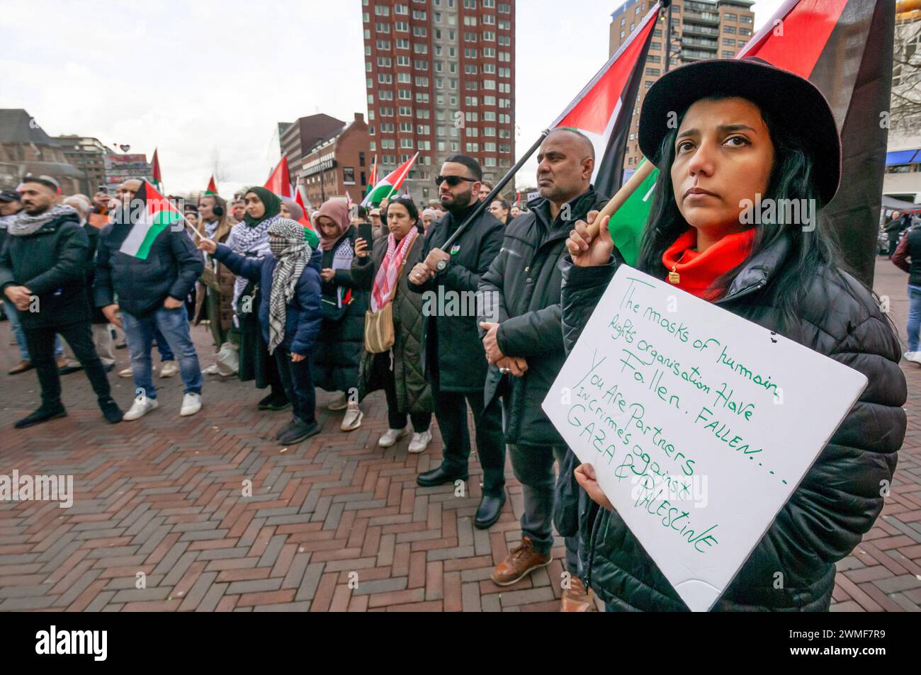 A protester holds a placard during the Open Off Rafah protest. HANDS ...