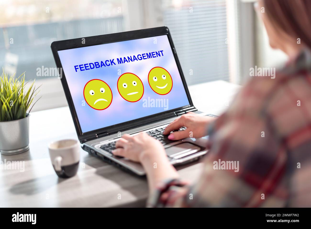 Laptop screen displaying a feedback management concept Stock Photo - Alamy