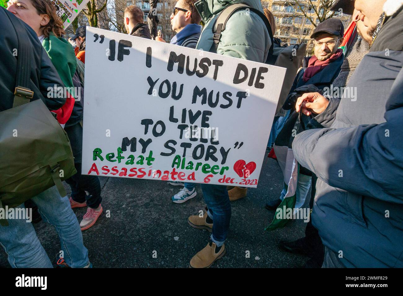 A protester holds a placard during the Open Off Rafah protest. HANDS ...
