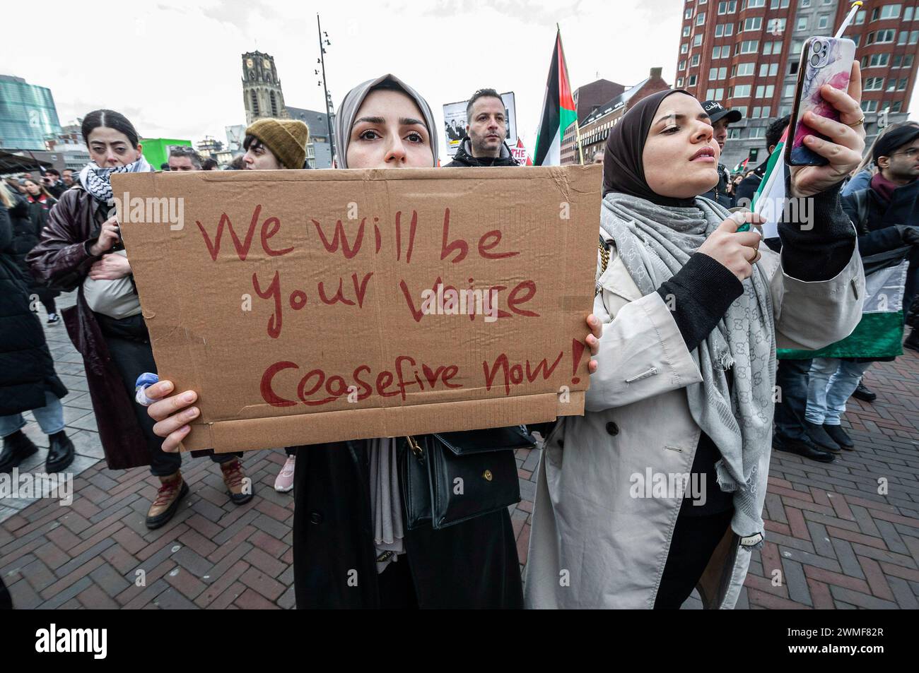A protester holds a placard during the Open Off Rafah protest. HANDS ...