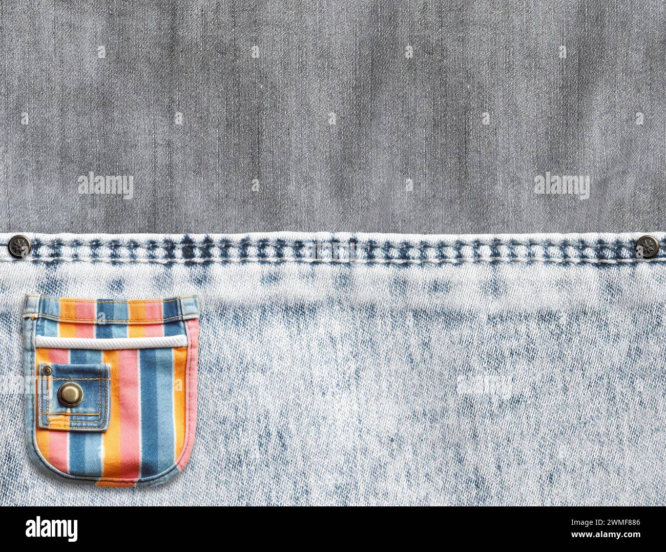 Grey and light grey denim background with a seam and colourful pocket ...
