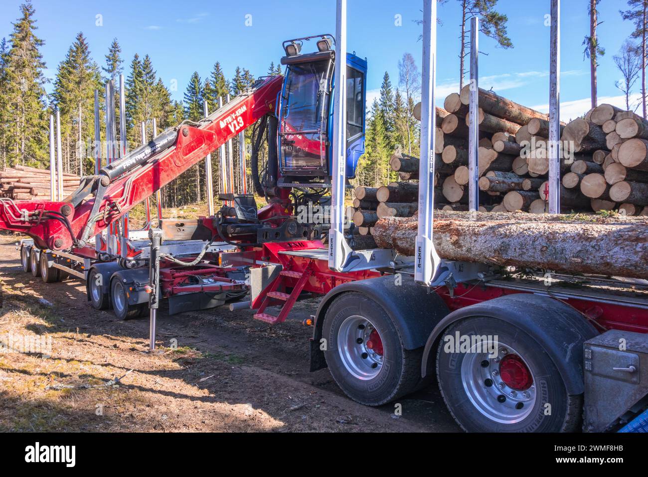 Trailer and a crane for timber transport Stock Photo - Alamy