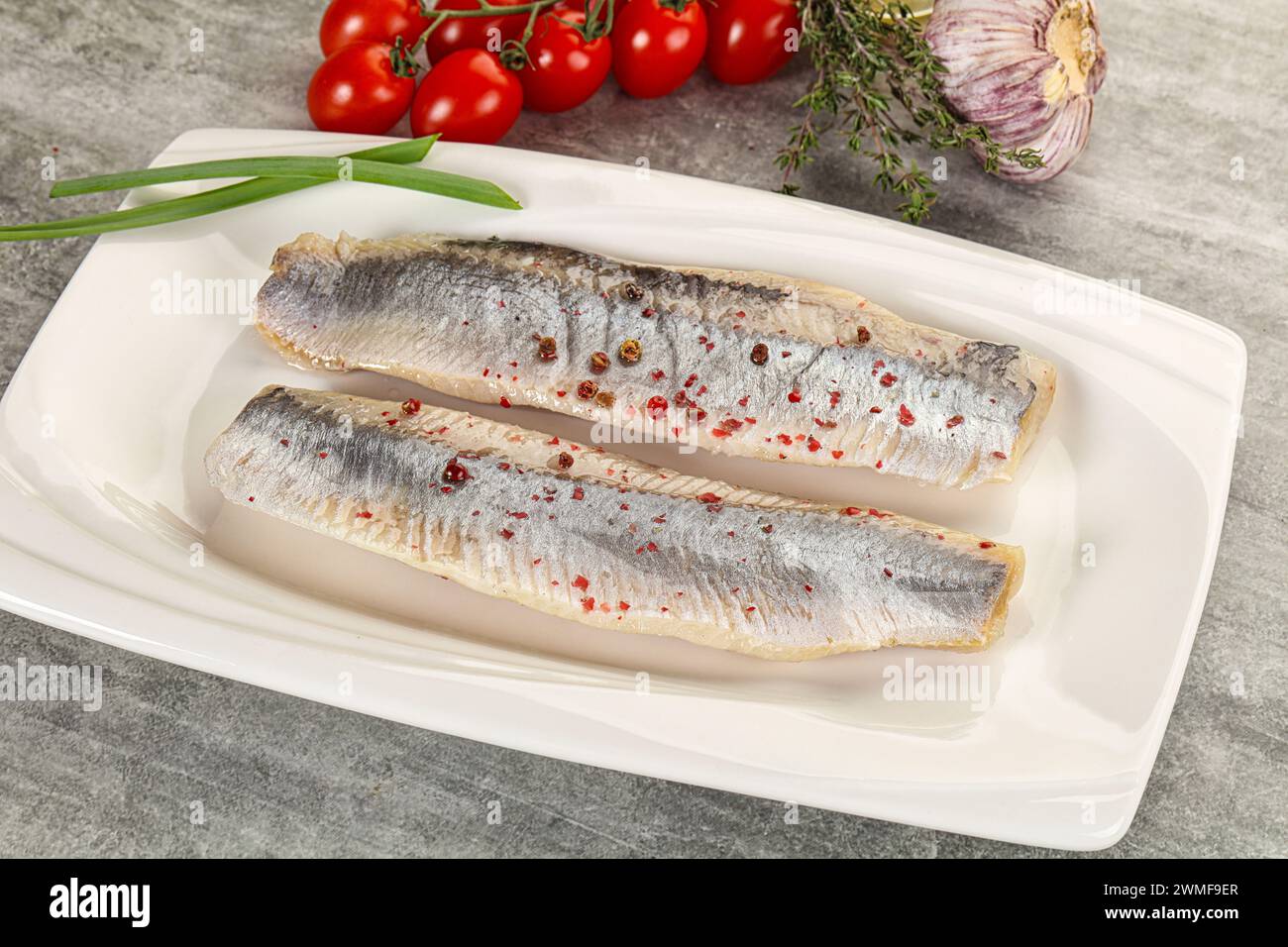 Marinated salted herring fillet with green onion Stock Photo - Alamy