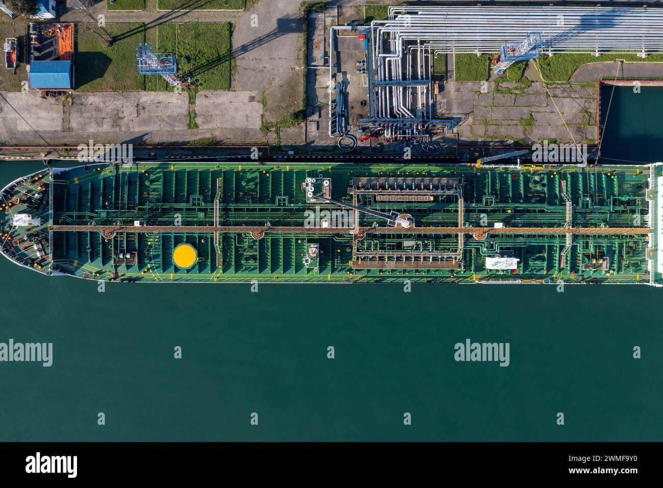 Top-down aerial shot of large LPG tanker ship docked at port with clear ...
